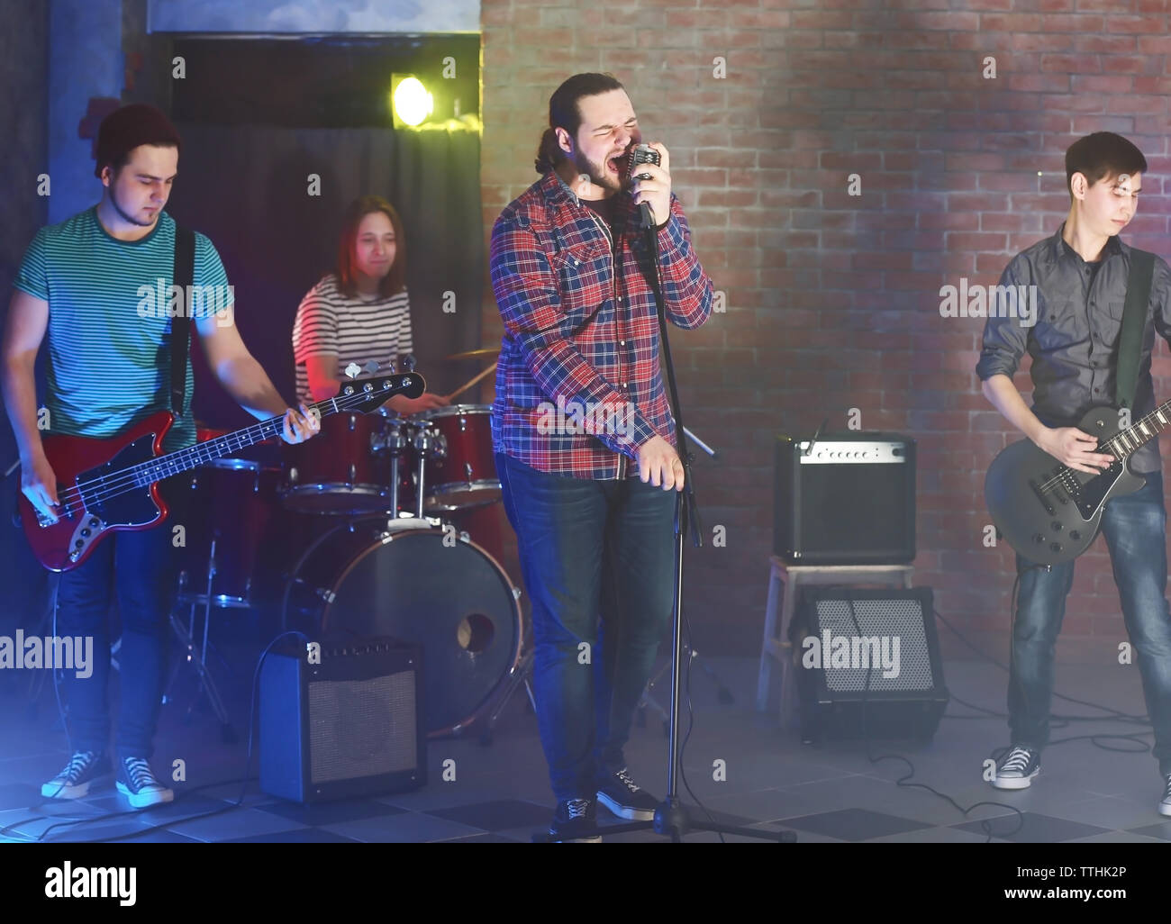 Music band performing on stage Stock Photo - Alamy
