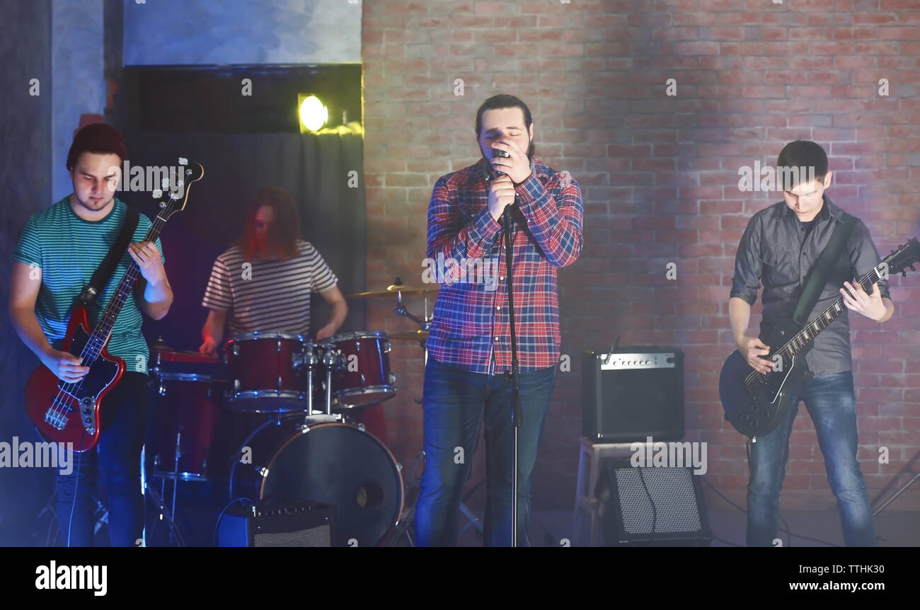 Music band performing on stage Stock Photo - Alamy