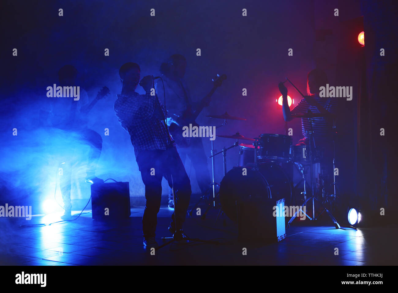 Music band performing on stage Stock Photo - Alamy