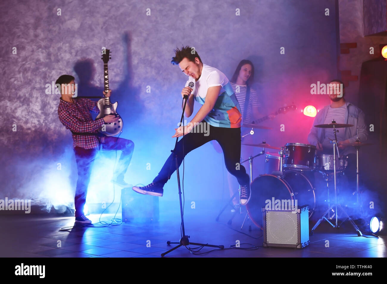 Music band performing on stage Stock Photo - Alamy