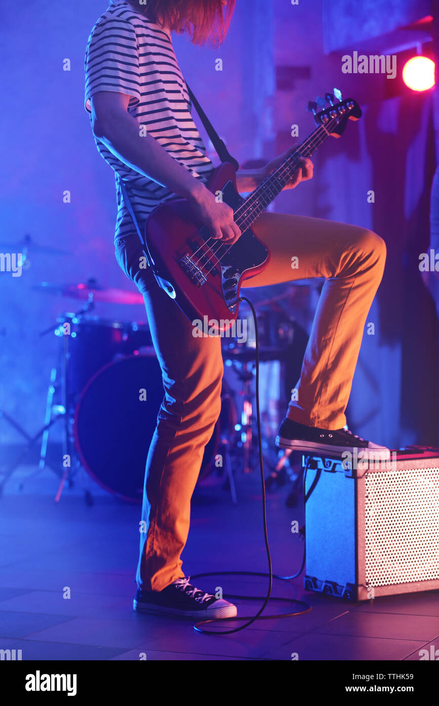 Man playing electric guitar on a stage Stock Photo - Alamy