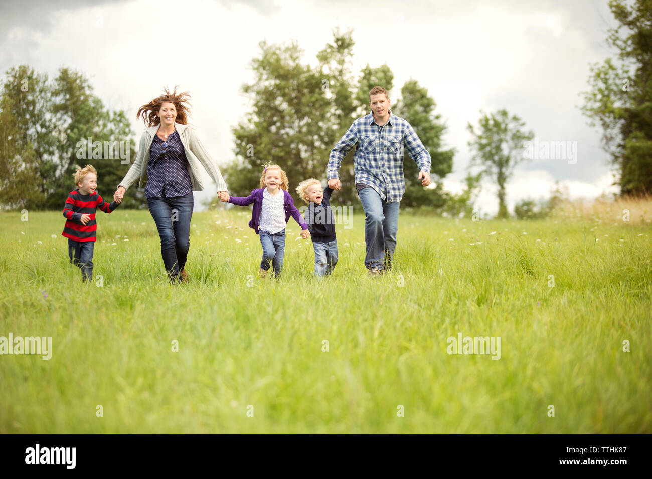 Family with three boys on field hi-res stock photography and images - Alamy