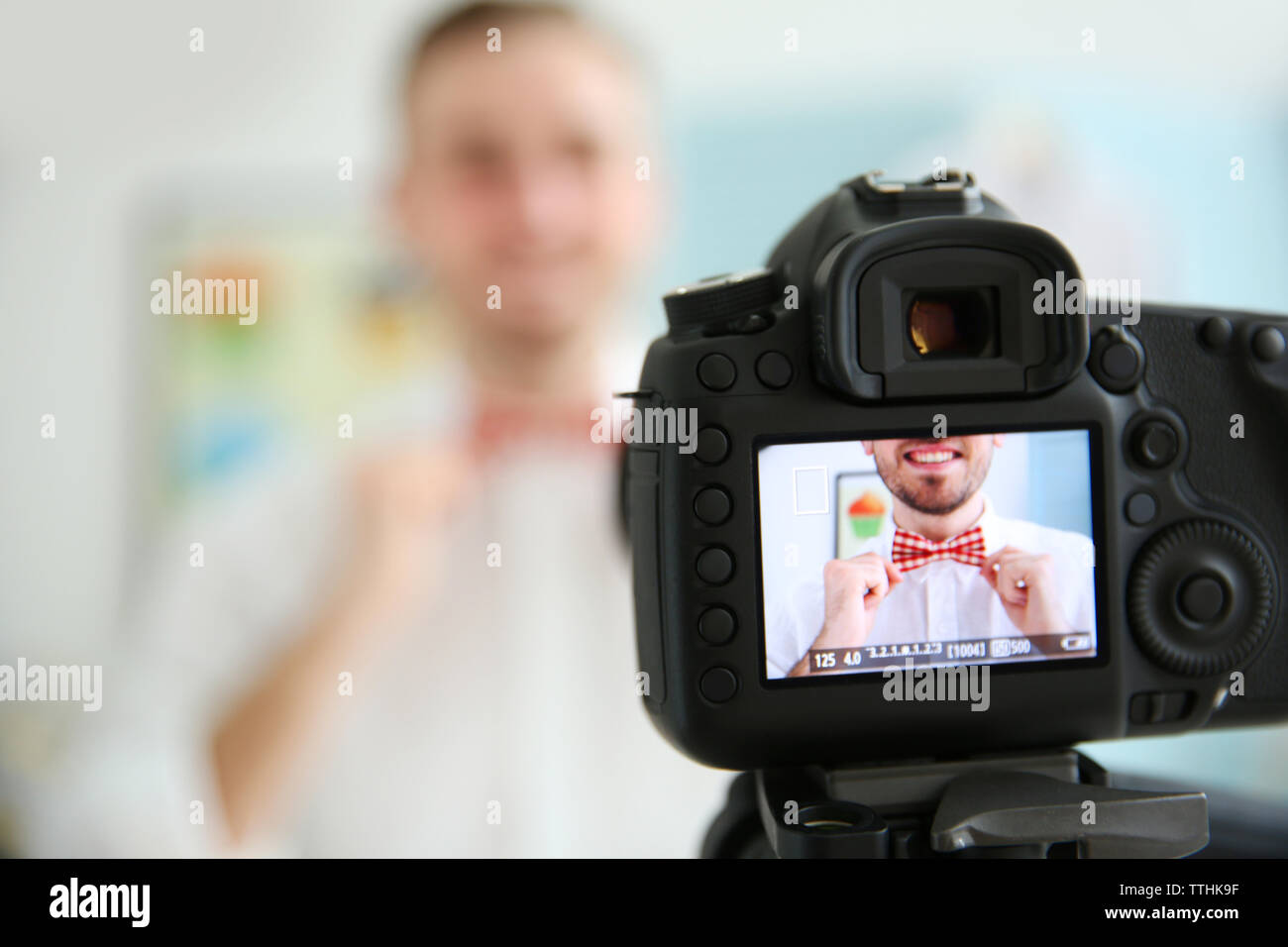 Young male blogger with tie bow on camera screen Stock Photo - Alamy