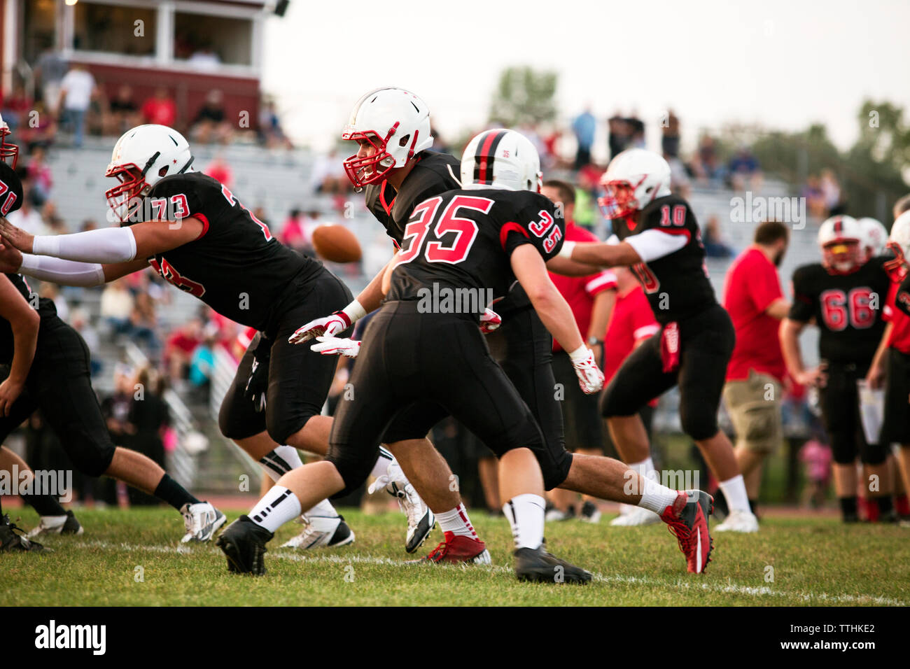American football team playing on field Stock Photo - Alamy