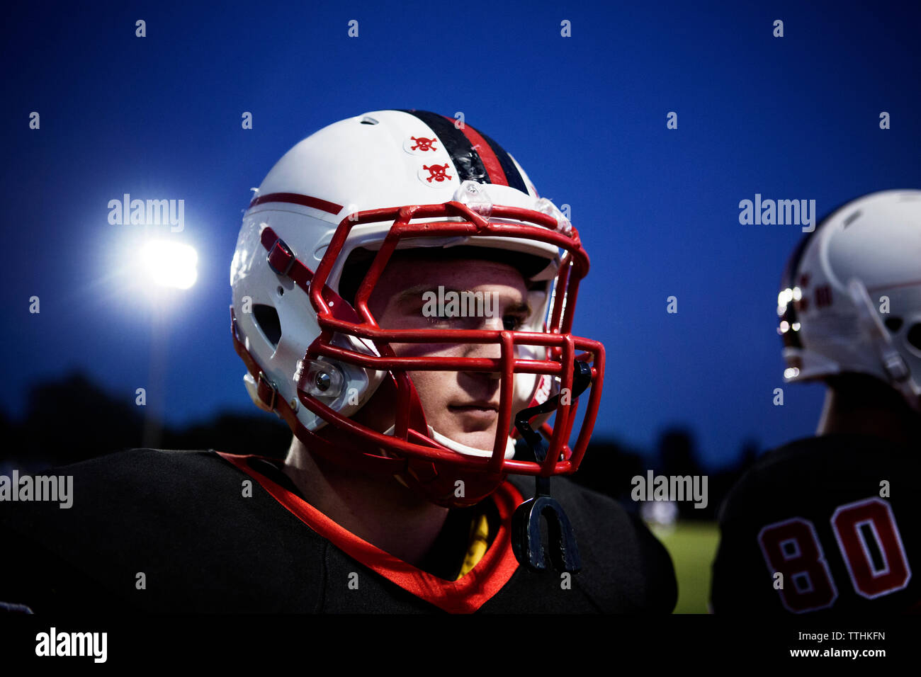Close-up of teenage American football player against sky at dusk Stock ...