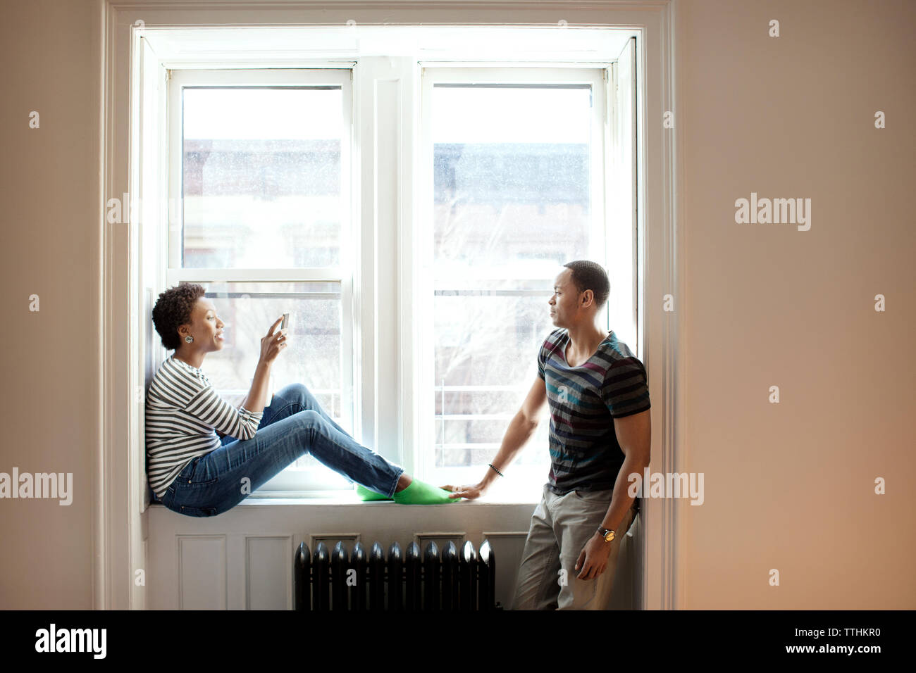 Woman sitting on radiator hi-res stock photography and images - Alamy