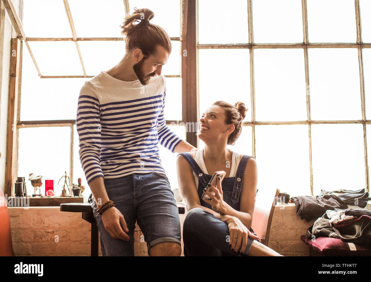Young couple looking face to face against window at home Stock Photo ...