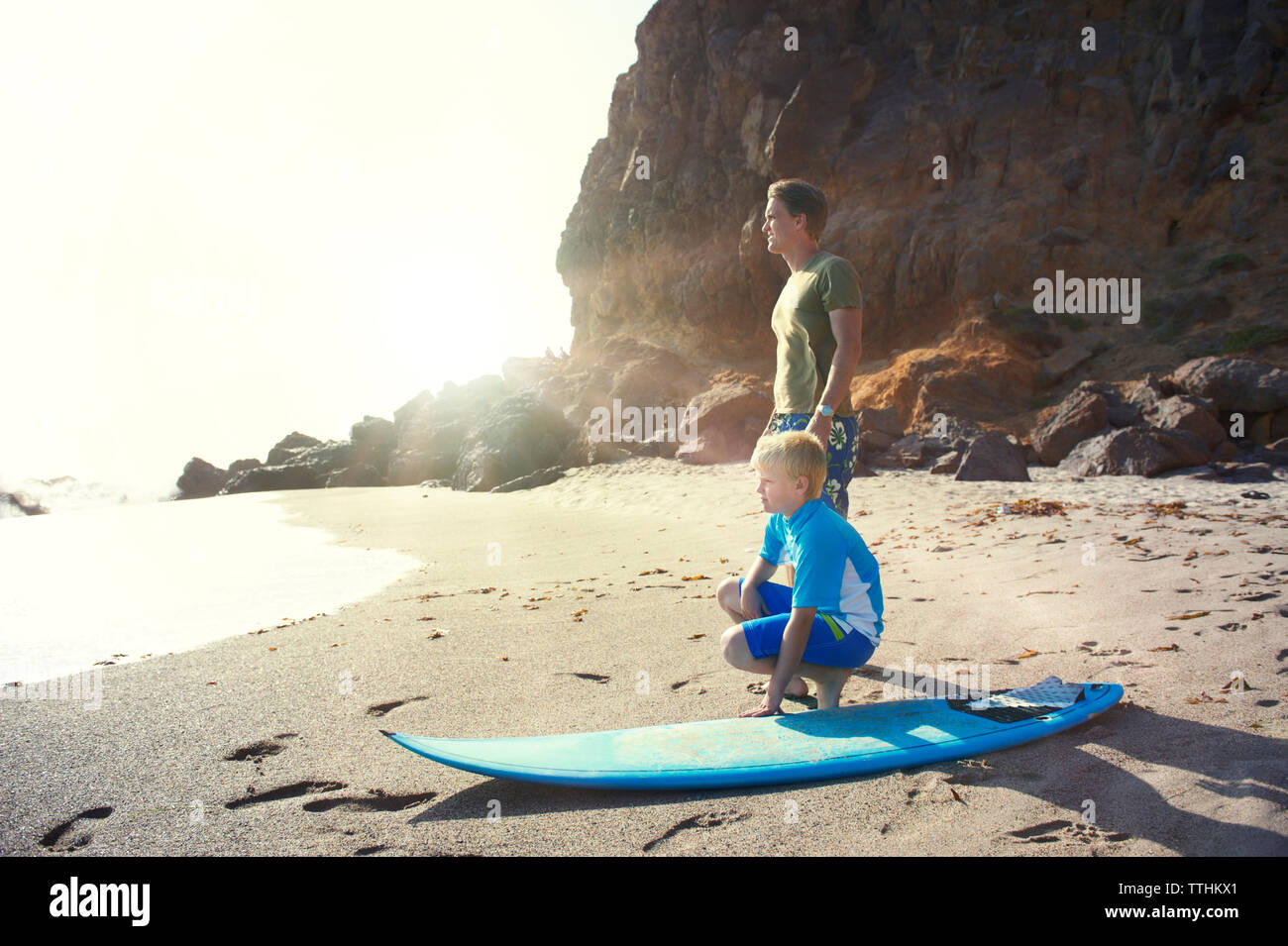 Boy standing on surfboard hi-res stock photography and images - Alamy
