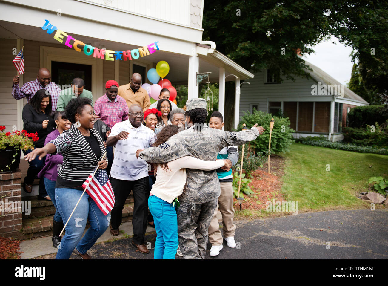 Female soldier embracing family and friends Stock Photo - Alamy