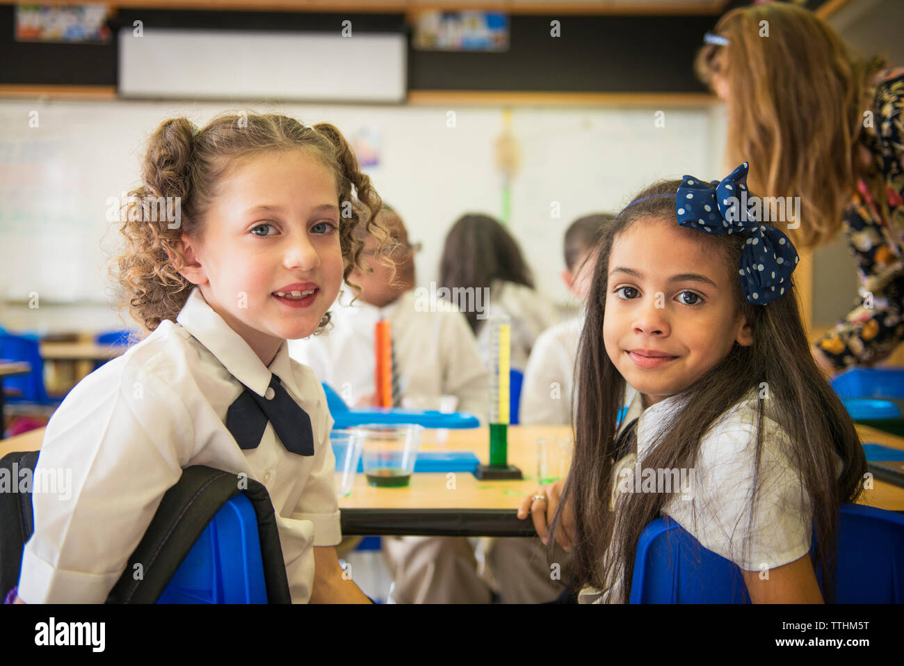 Two smiling schoolgirls in classroom hi-res stock photography and ...