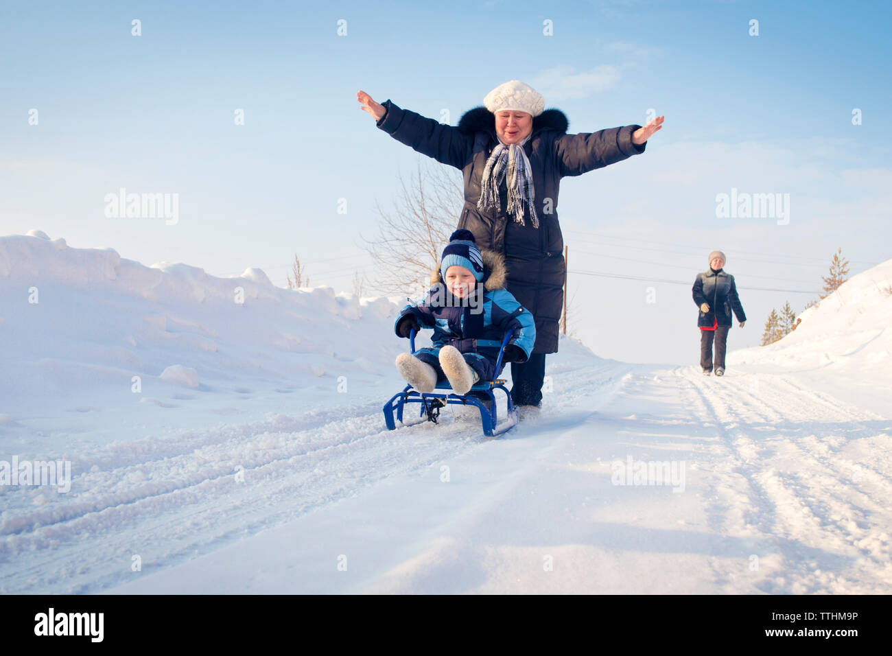 Boy pushing sled hi-res stock photography and images - Alamy