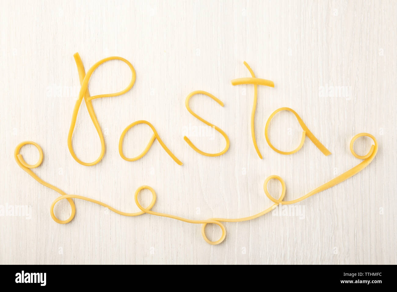 Word PASTA made of cooked spaghetti on wooden background Stock Photo ...