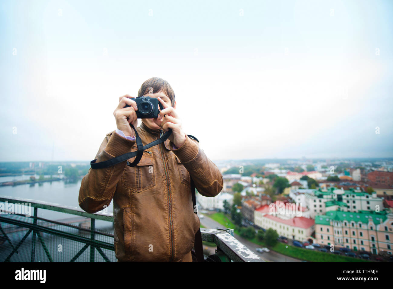 Young man standing railing observation hi-res stock photography and ...