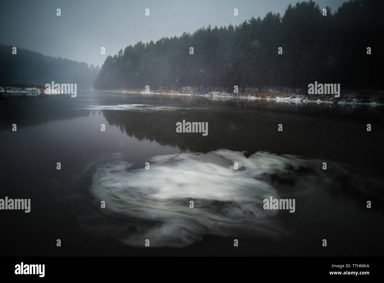 Scenic view of frozen river against trees Stock Photo - Alamy