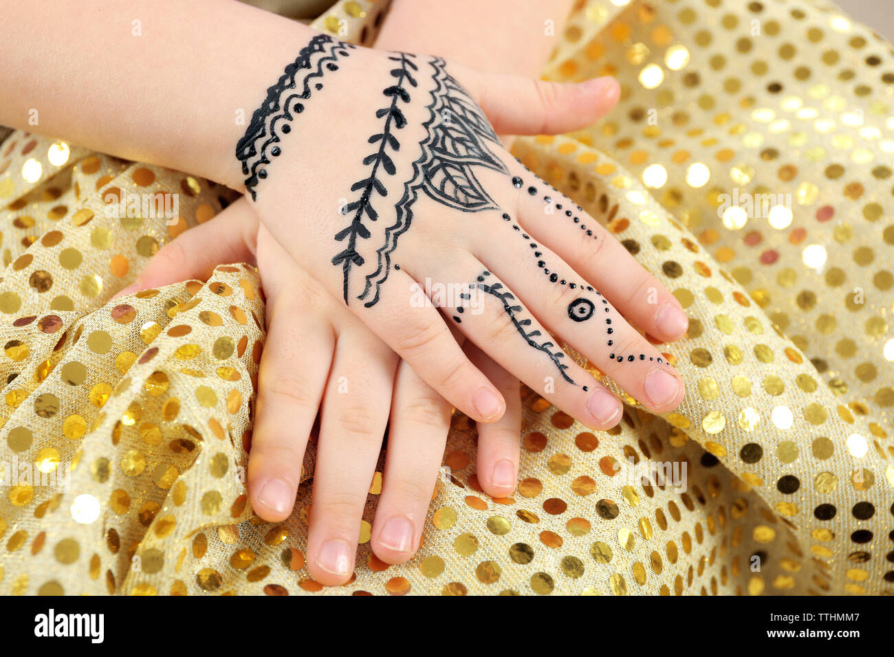 Henna ornaments on girl's hand on color cloth background Stock Photo ...