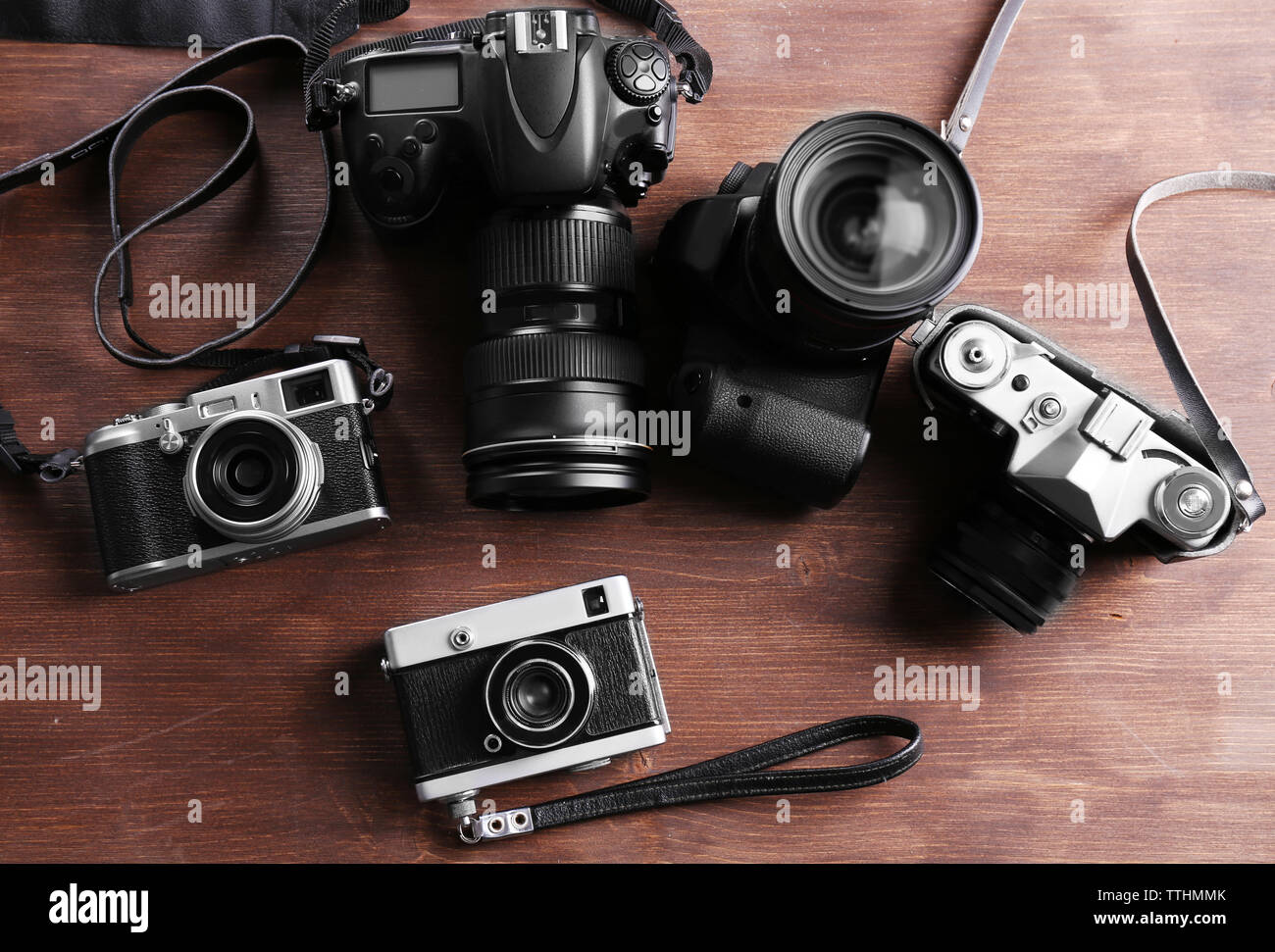 Modern and retro cameras on wooden background Stock Photo - Alamy