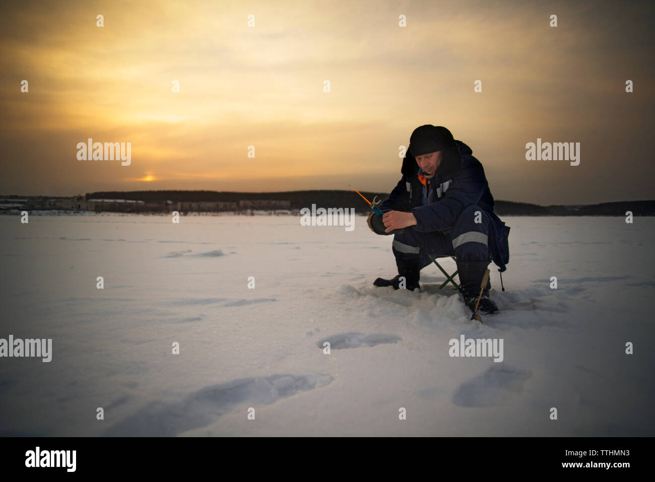 Man sitting on ice hi-res stock photography and images - Alamy