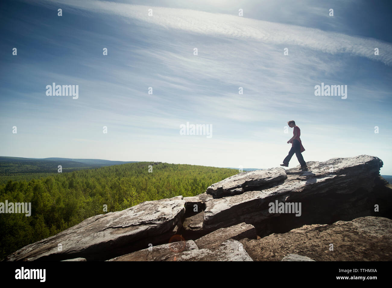 Woman standing at rocks hi-res stock photography and images - Alamy
