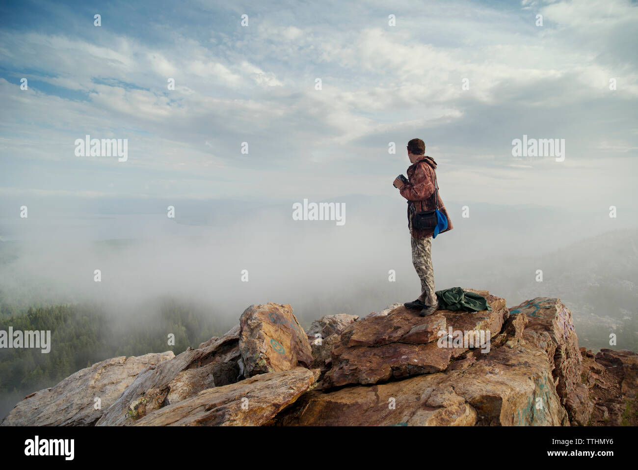 Man standing on rocks hi-res stock photography and images - Alamy