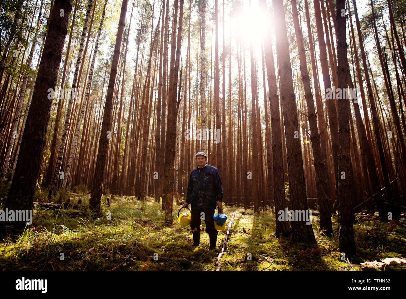 Male worker standing amidst hi-res stock photography and images - Alamy
