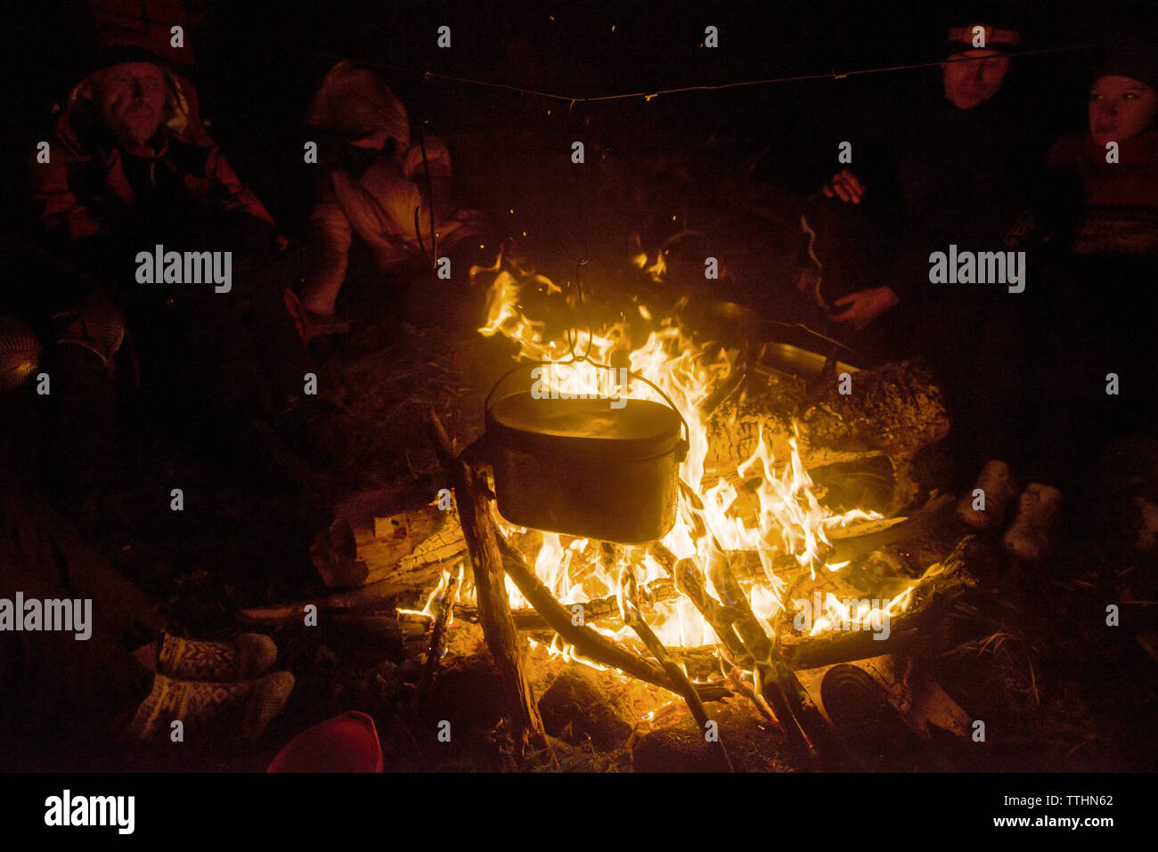 Group people sitting around bonfire hi-res stock photography and images ...