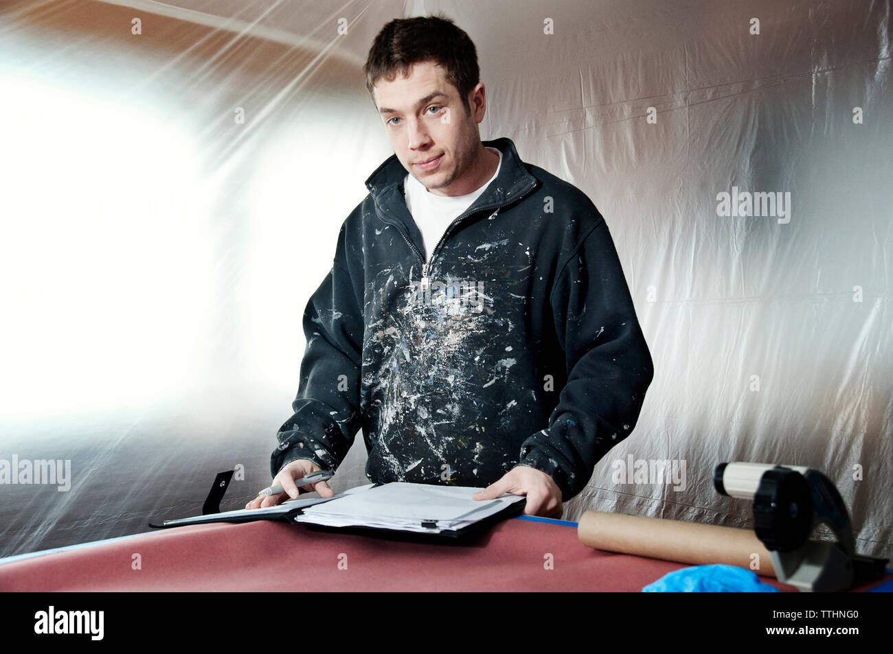 Portrait of man holding document on table at workshop Stock Photo - Alamy