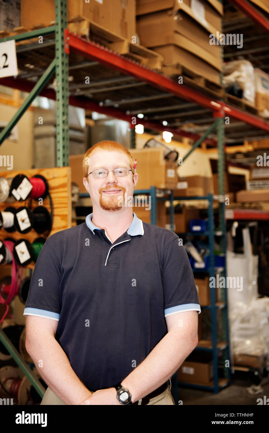 Portrait of confident worker standing in warehouse Stock Photo - Alamy
