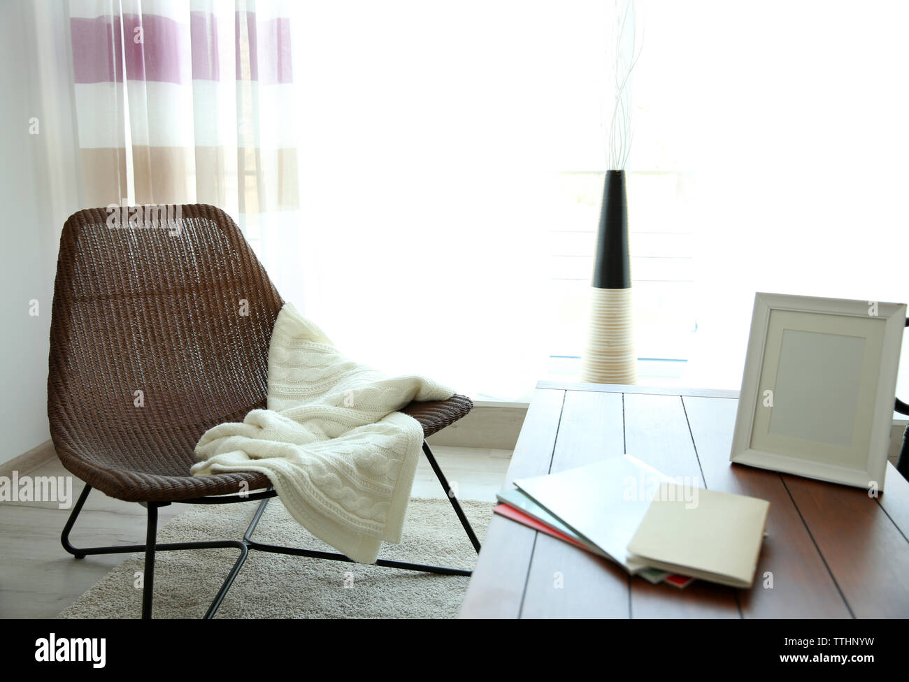 Modern living room interior. Chair beside wooden table Stock Photo - Alamy