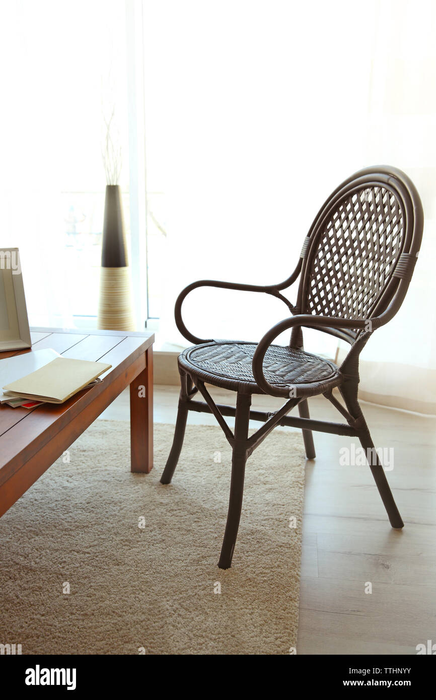 Modern living room interior. Chair beside wooden table Stock Photo - Alamy