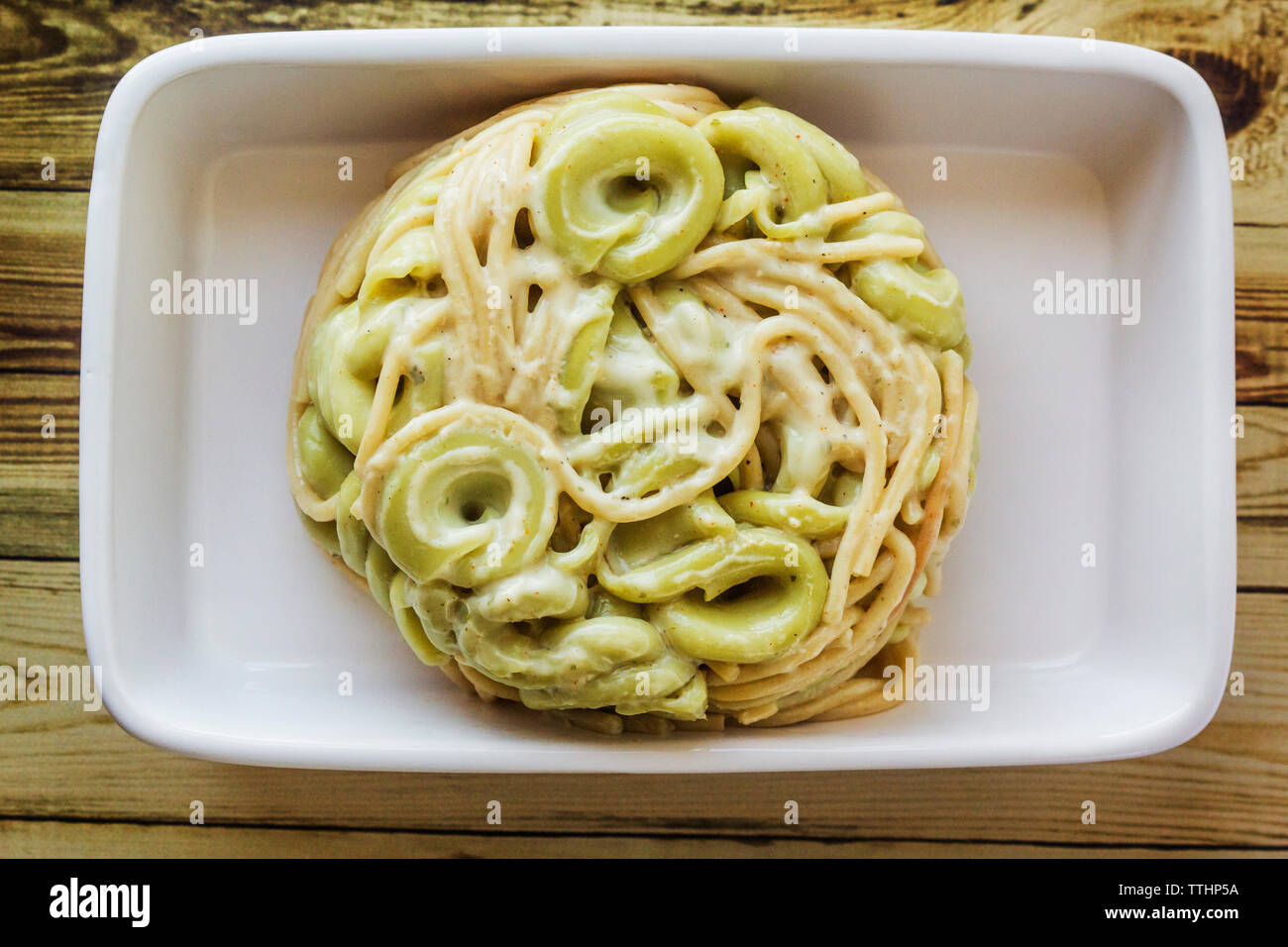 Overhead view of spaghetti served in tray on table Stock Photo - Alamy