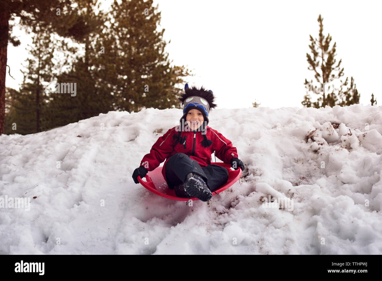 Boy on sled hi-res stock photography and images - Alamy