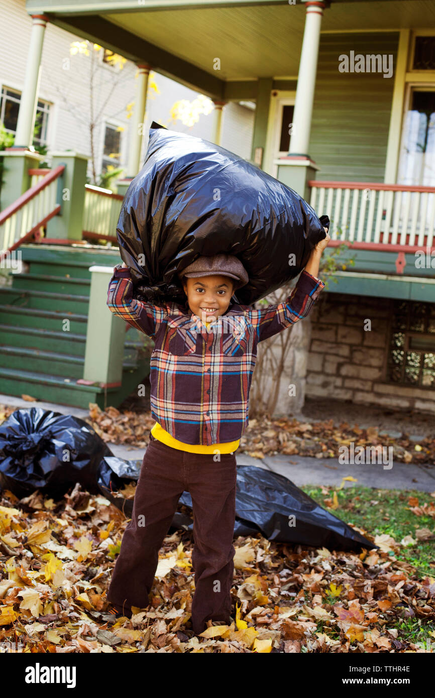 Boy carrying garbage bag hi-res stock photography and images - Alamy