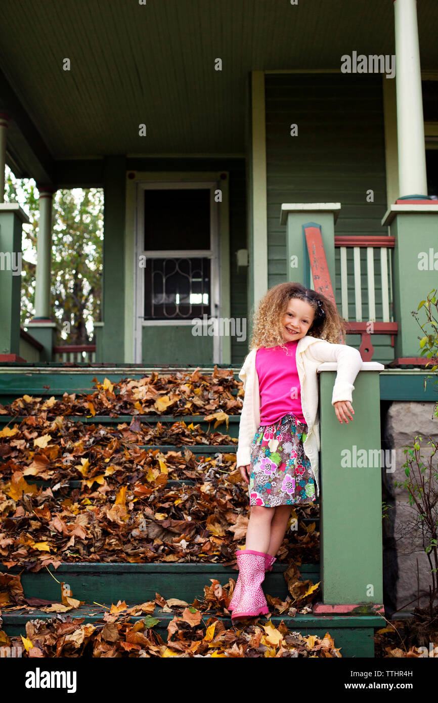 Portrait of girl standing on staircase of house Stock Photo - Alamy