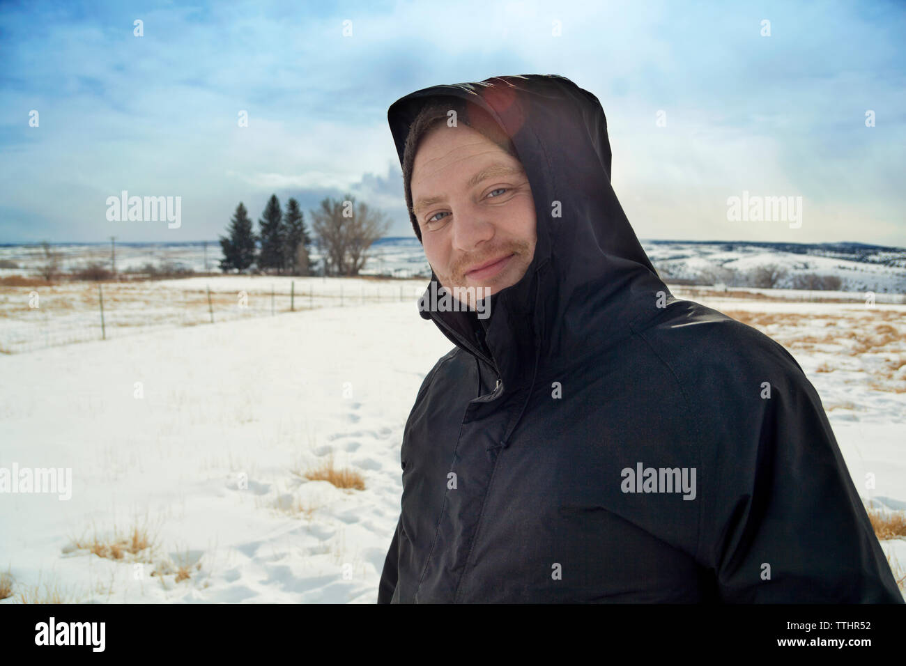 Hooded young man standing hi-res stock photography and images - Alamy