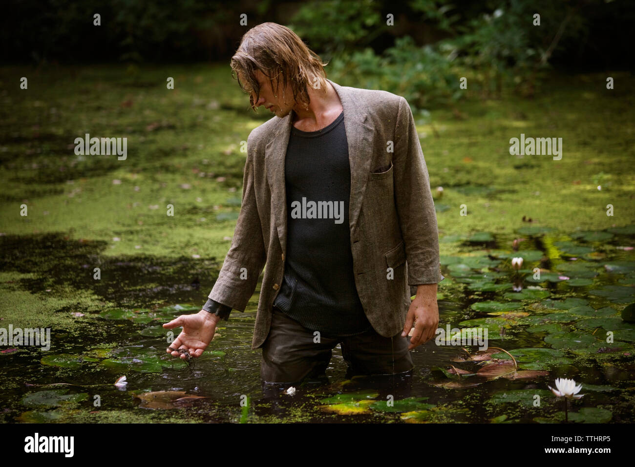 Man standing in swamp Stock Photo - Alamy