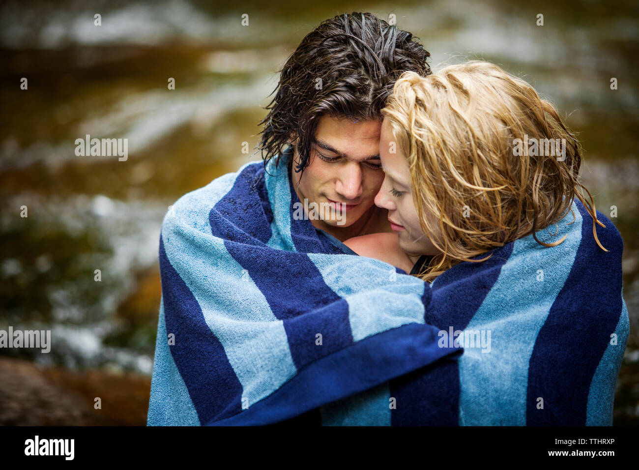 Affectionate couple wrapped in towel Stock Photo - Alamy