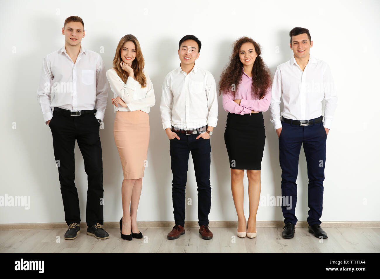 Portrait of young people against white wall background Stock Photo - Alamy