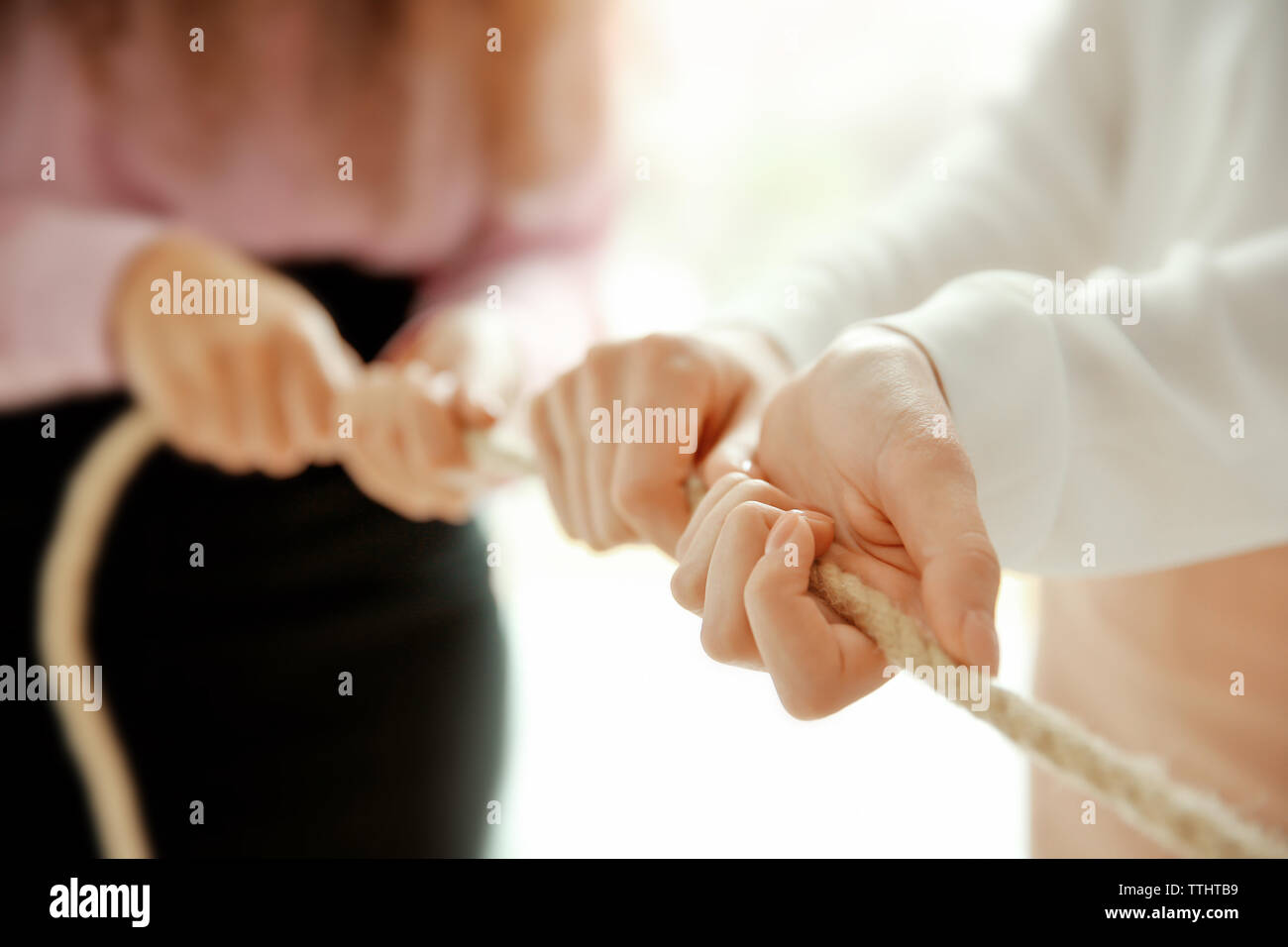 People hands pulling rope for playing tug of war closeup Stock Photo ...