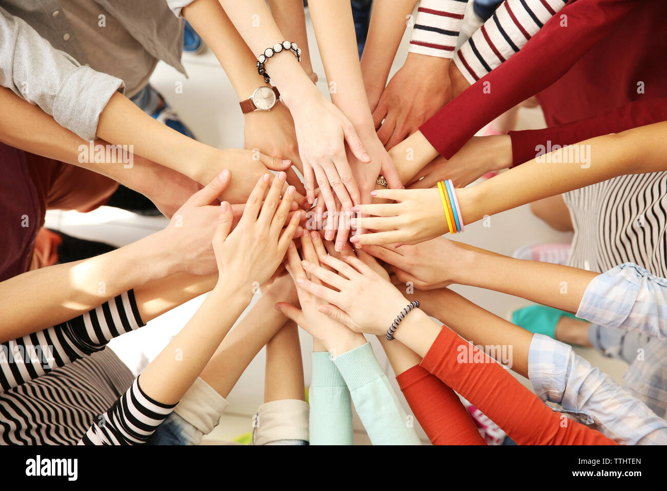 Group of people hands together Stock Photo - Alamy