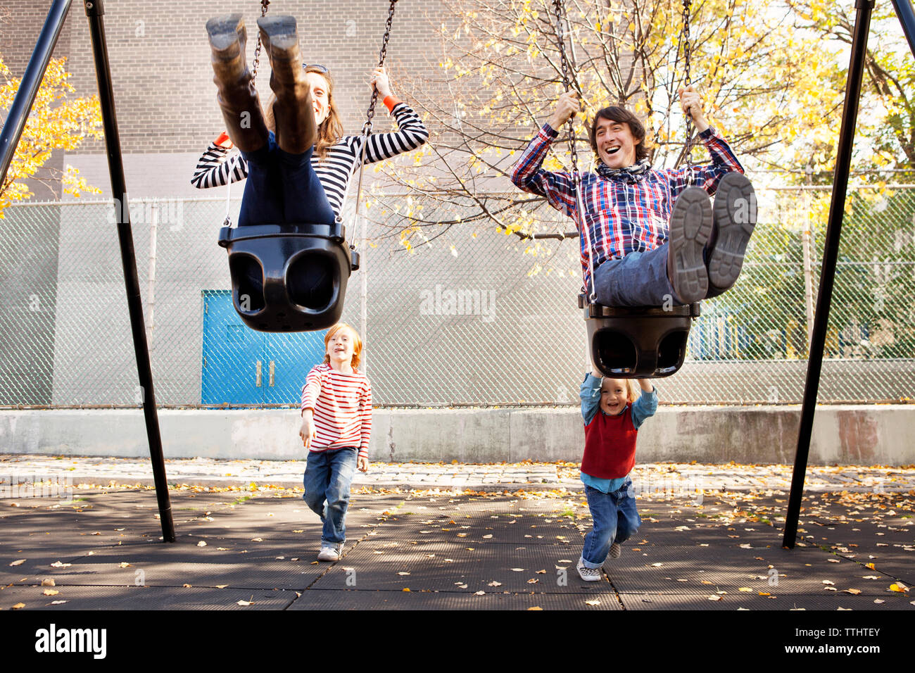 Children playing park fence hi-res stock photography and images - Alamy