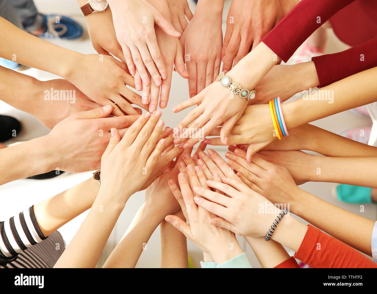 Group of people hands together Stock Photo - Alamy