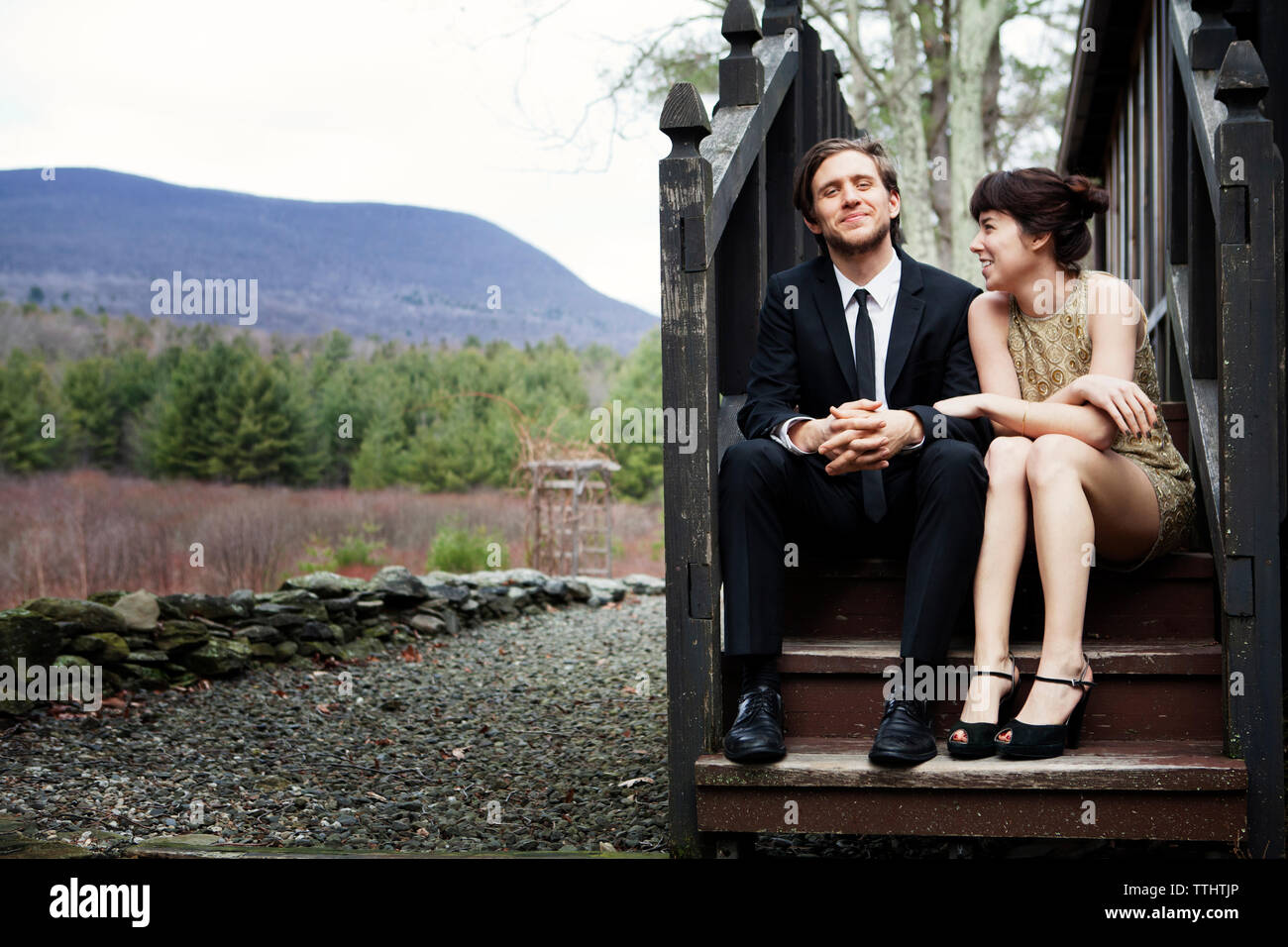 Happy couple sitting on steps Stock Photo - Alamy