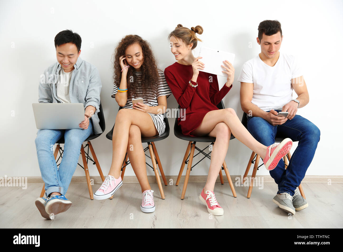 Group of people with digital devices waiting for interview indoors ...