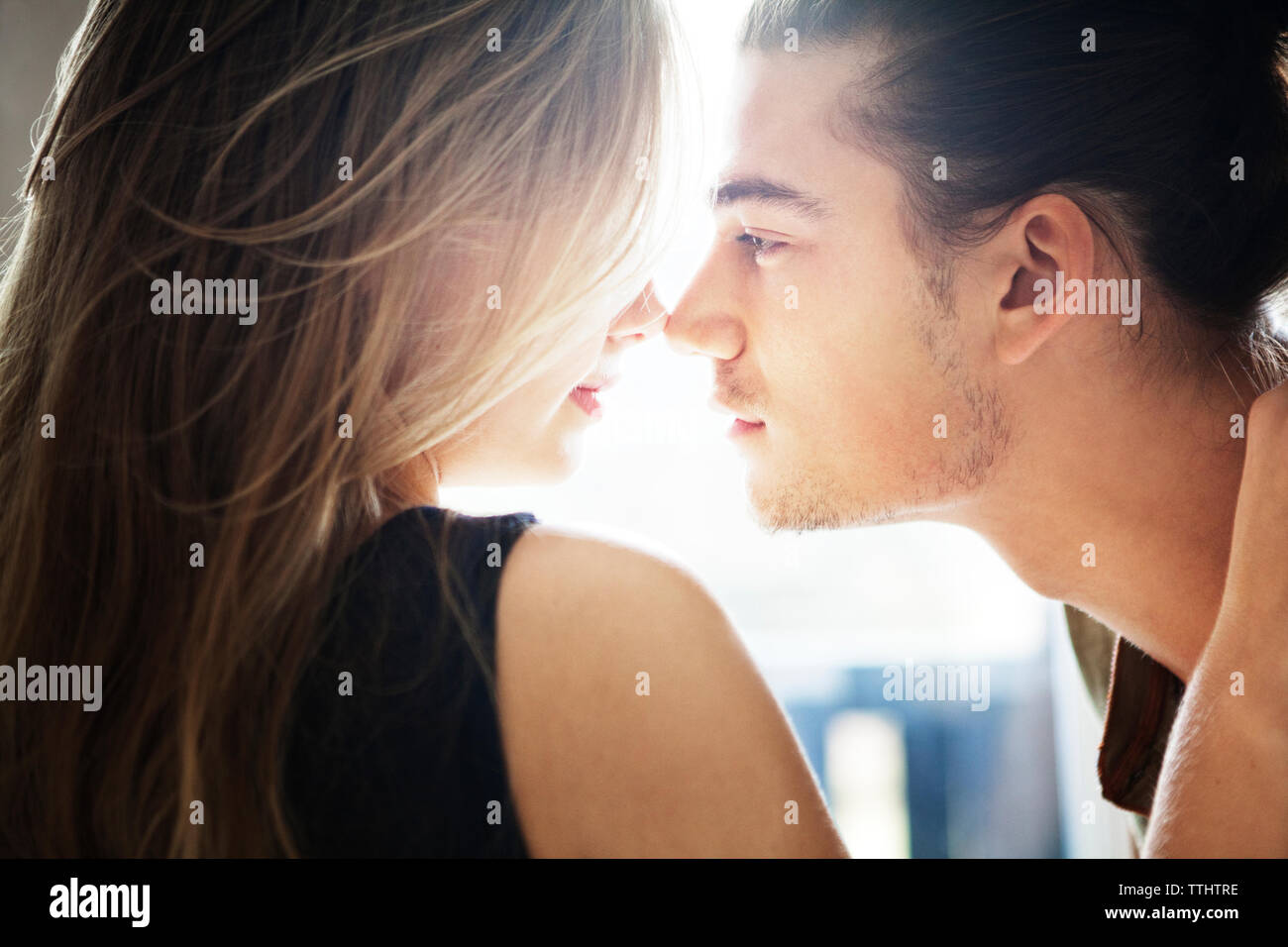 Side view of romantic couple Stock Photo - Alamy