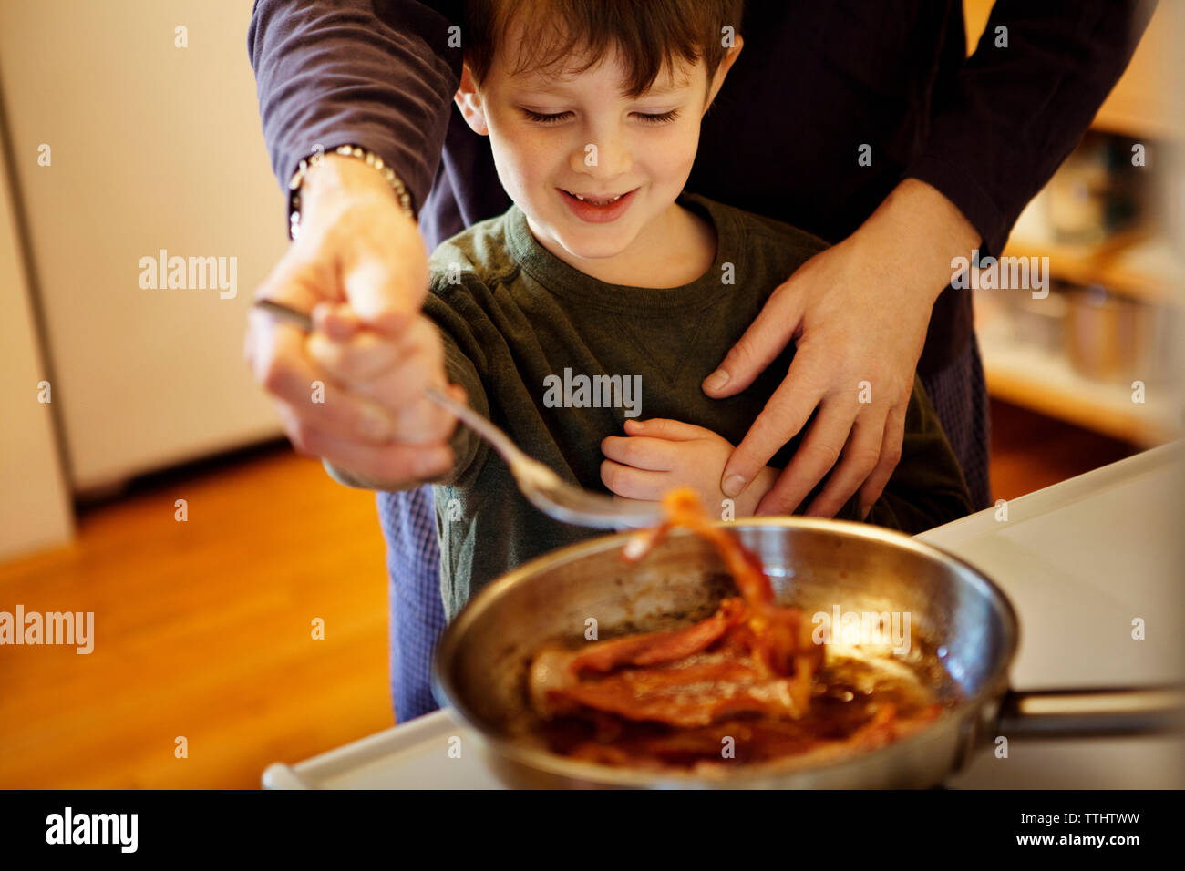 Father and son cooking food in kitchen Stock Photo - Alamy