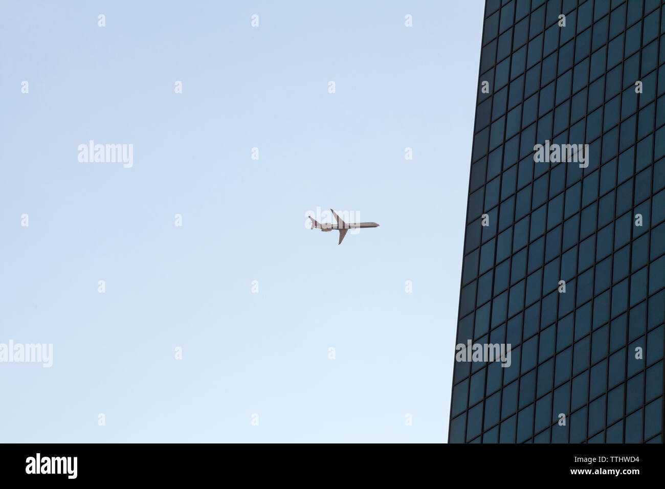 Airplane in clear sky Stock Photo - Alamy