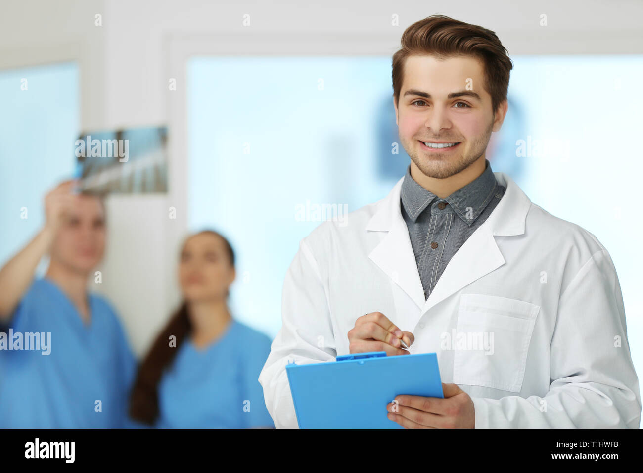 A male doctor holding a clipboard in hospital Stock Photo - Alamy