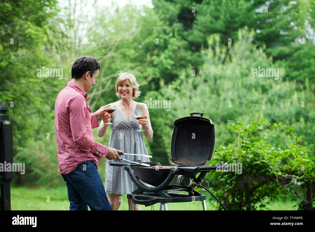 Couple having barbecue on hi-res stock photography and images - Alamy