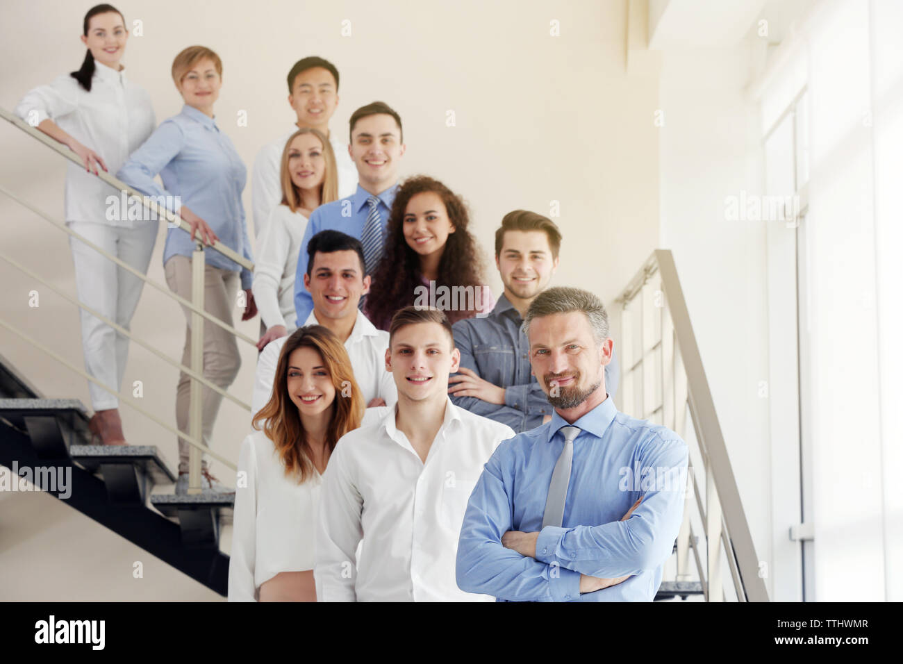 Group of people standing on the stairs Stock Photo - Alamy
