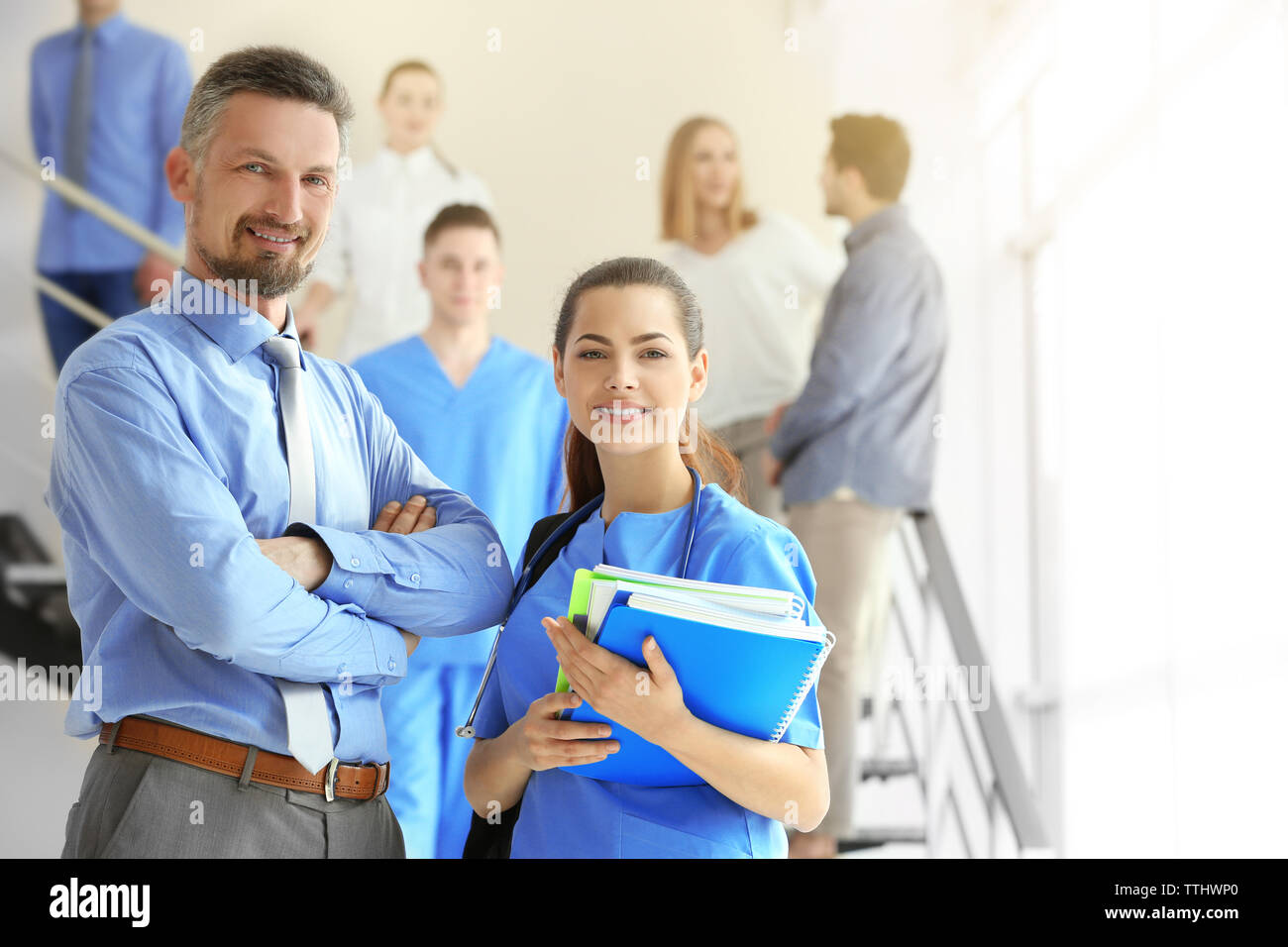 Young female medical student and professor standing indoors Stock Photo ...